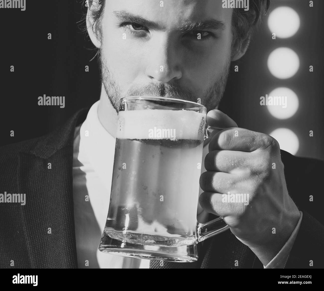 Man holds glass red Black and White Stock Photos & Images - Alamy