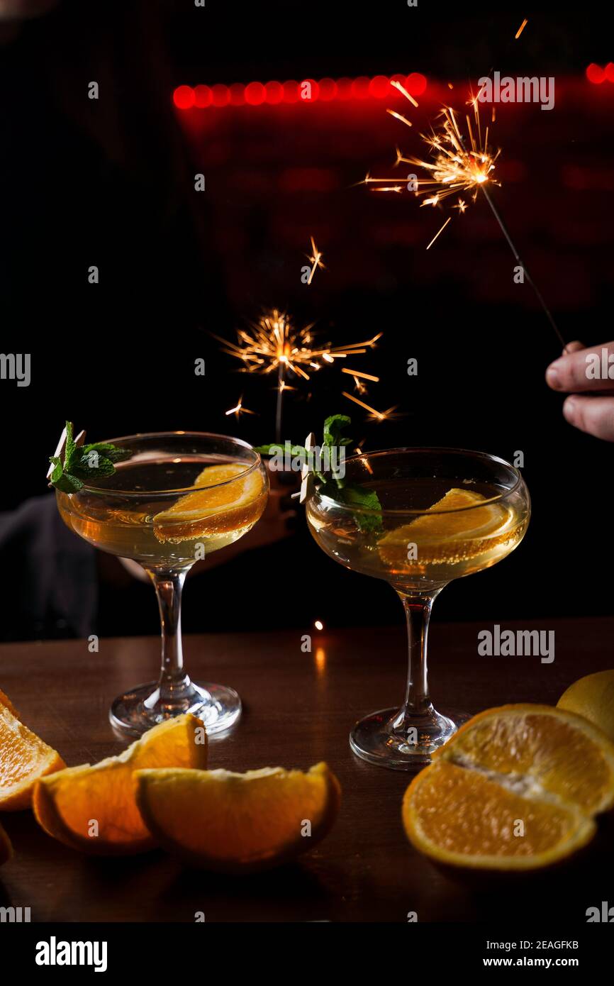 Celebrating new year eve 2022 with sparklers fireworks and drinking ...