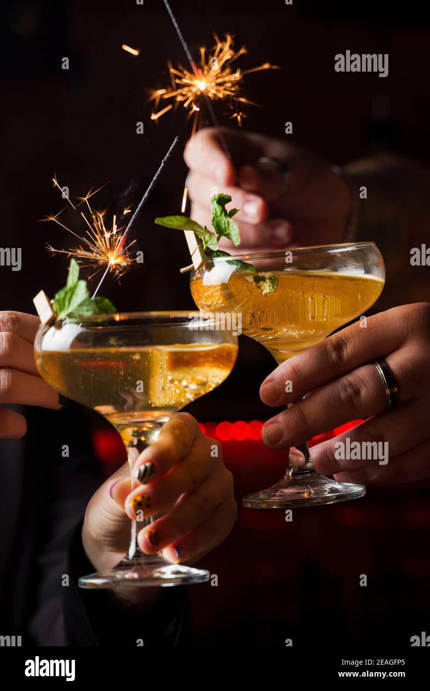 Hands with champagne glass fireworks hi-res stock photography and ...