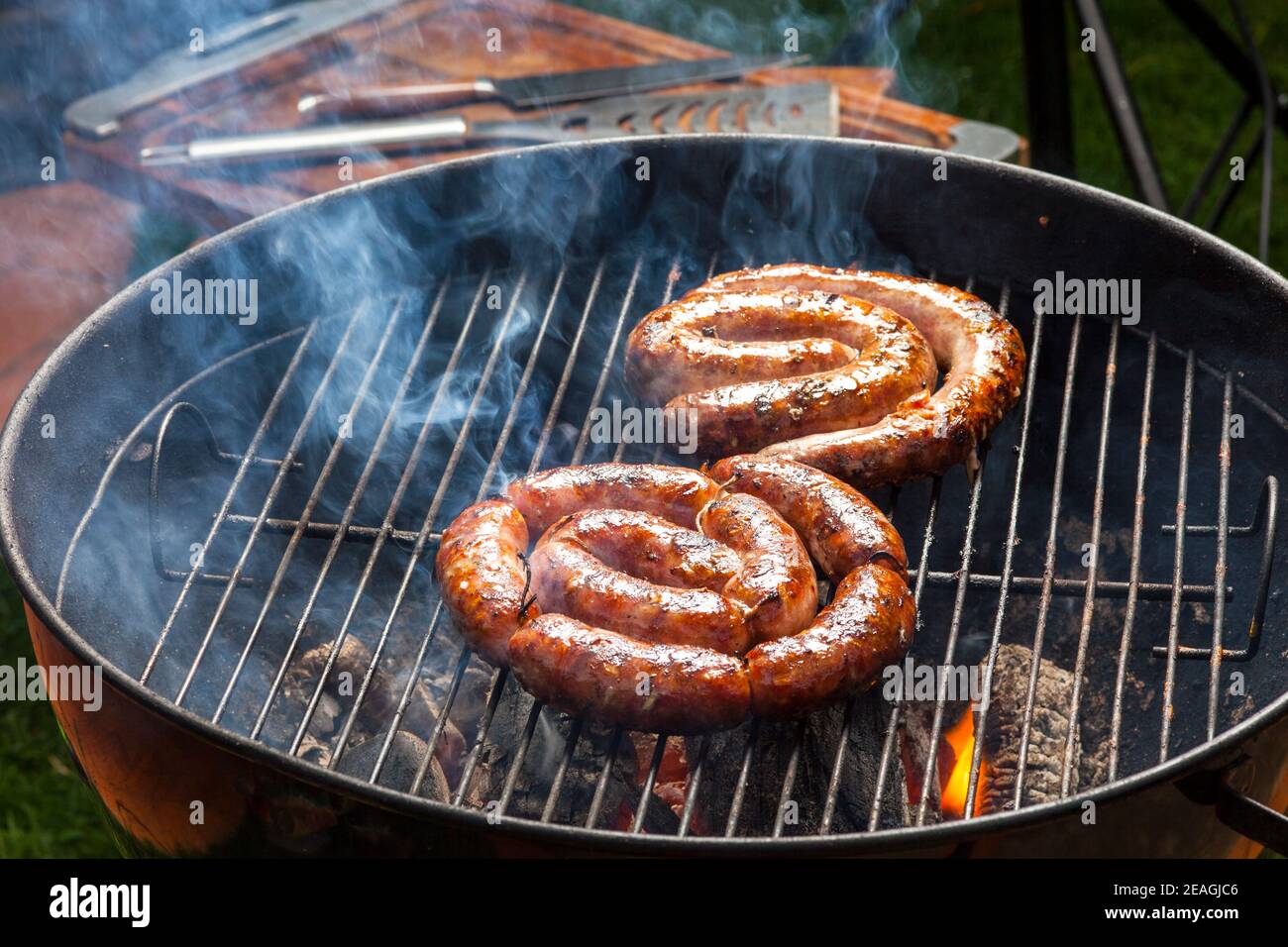 BBQ with fiery sausages on the grill Stock Photo - Alamy