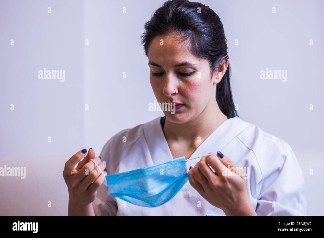 Female doctor taking off mask hi-res stock photography and images - Alamy