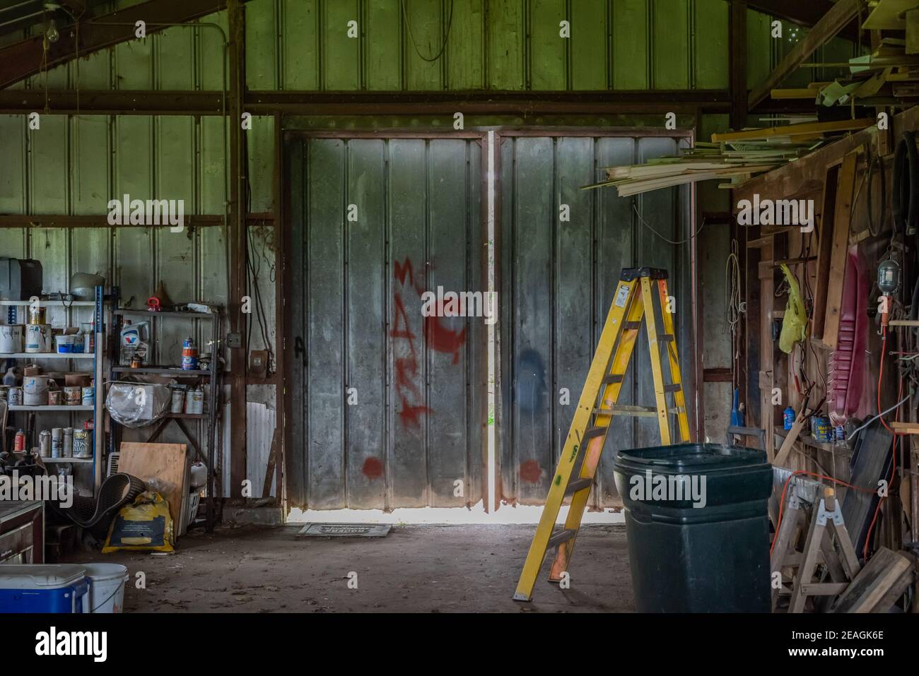 Cluttered metal farm storage barn Stock Photo - Alamy