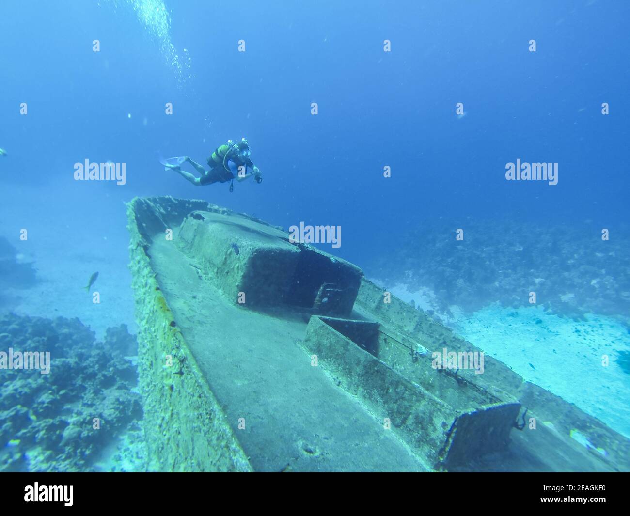 Scuba diver swimming near an old drown boat Stock Photo - Alamy