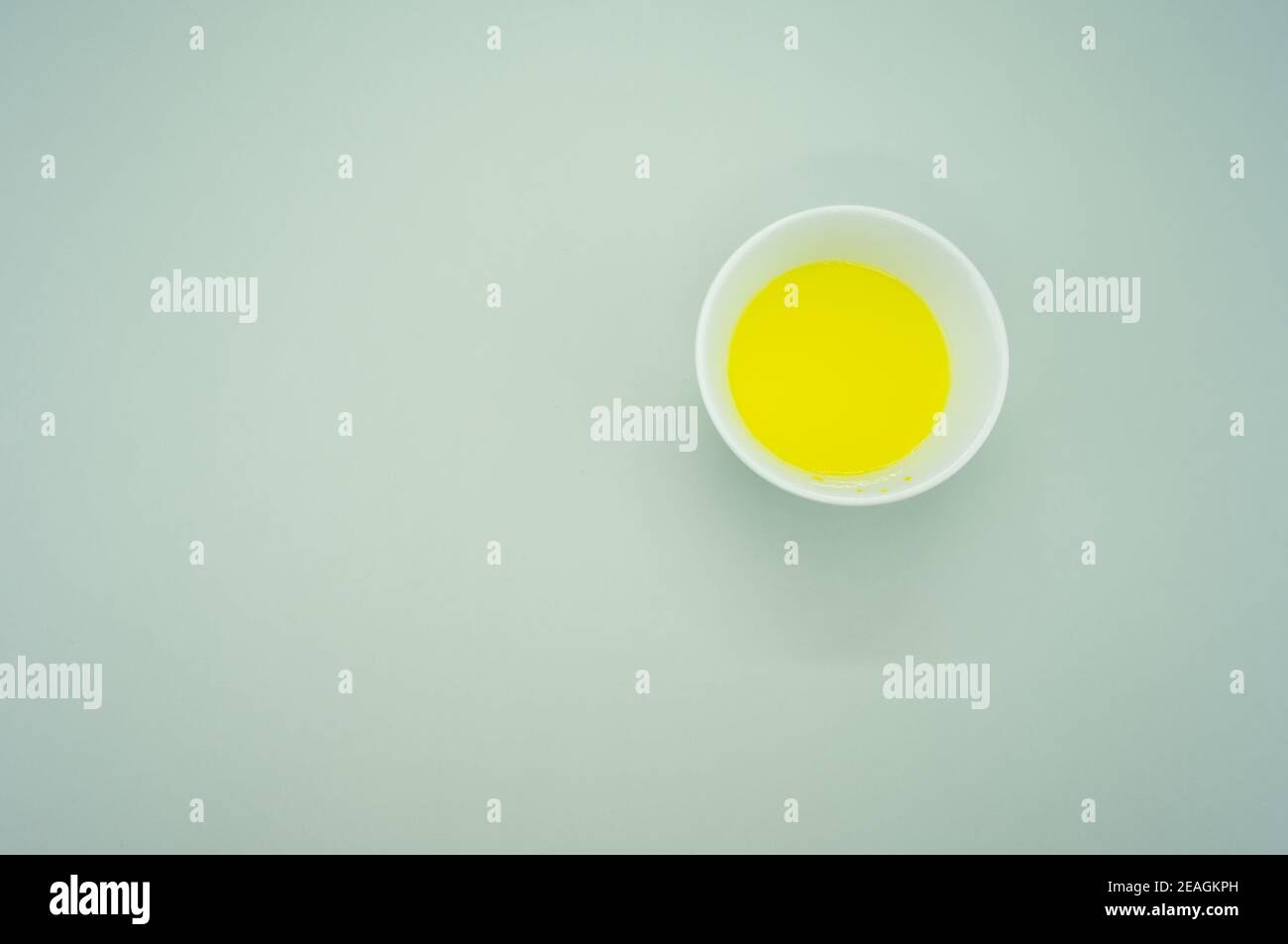 Top view of yellow liquid watercolor paint on a bowl isolated on gray ...