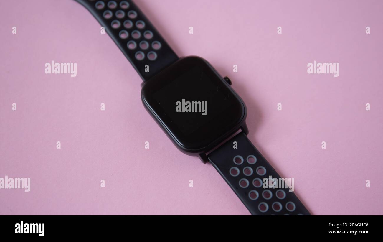 Top view of a smart watch on a pink surface Stock Photo - Alamy