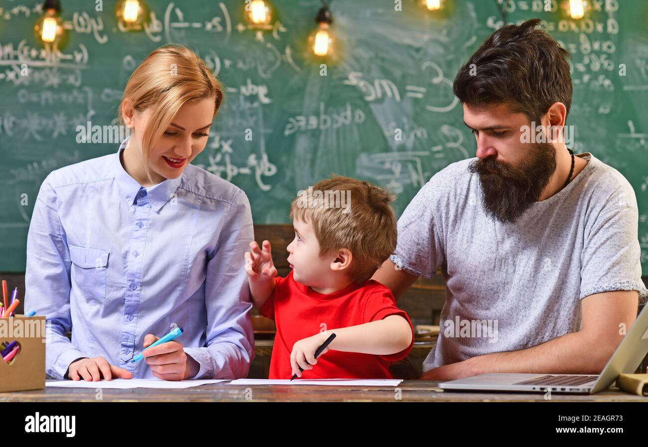 Child with mother and father at school. Little child study with parents ...