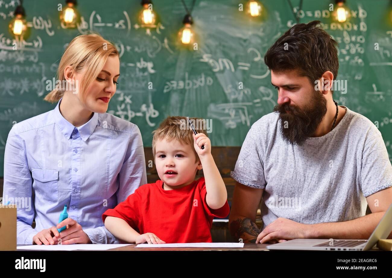 Child in home family school. Schoolboy studying homework during her ...