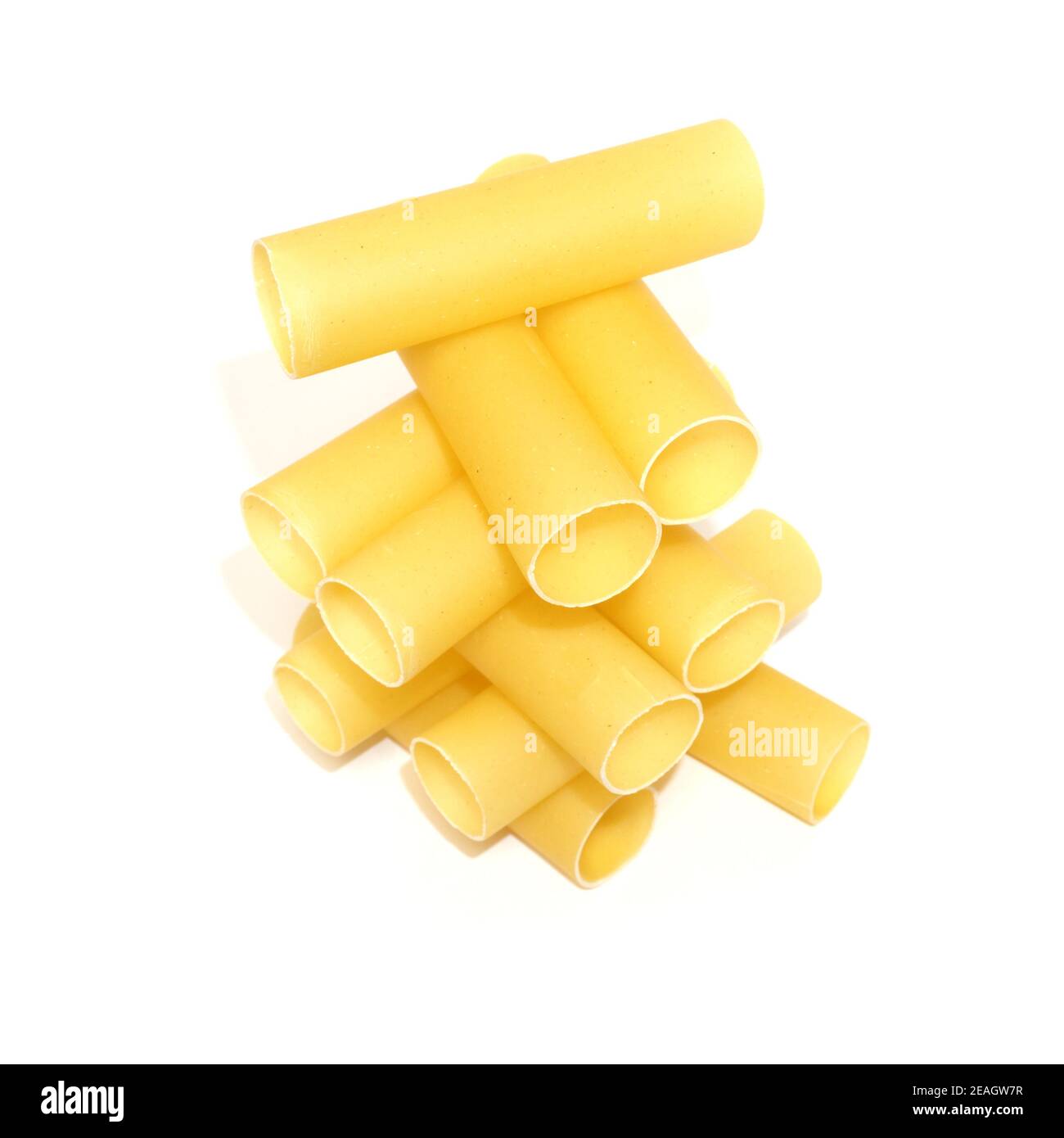 Yellow cannelloni pasta isolated on white background Stock Photo - Alamy