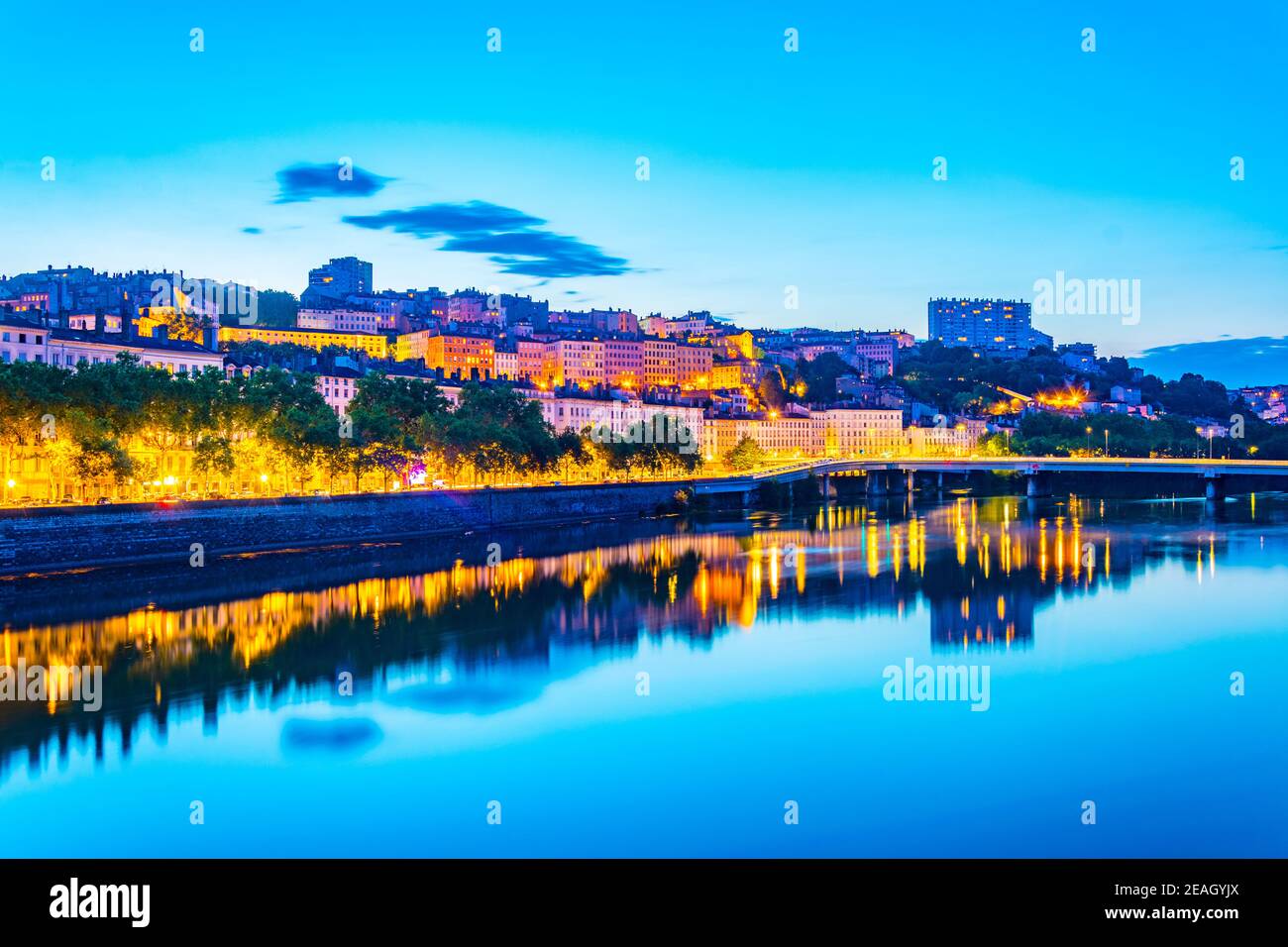 Night view of illuminated riverside of Rhone river in Lyon, France ...