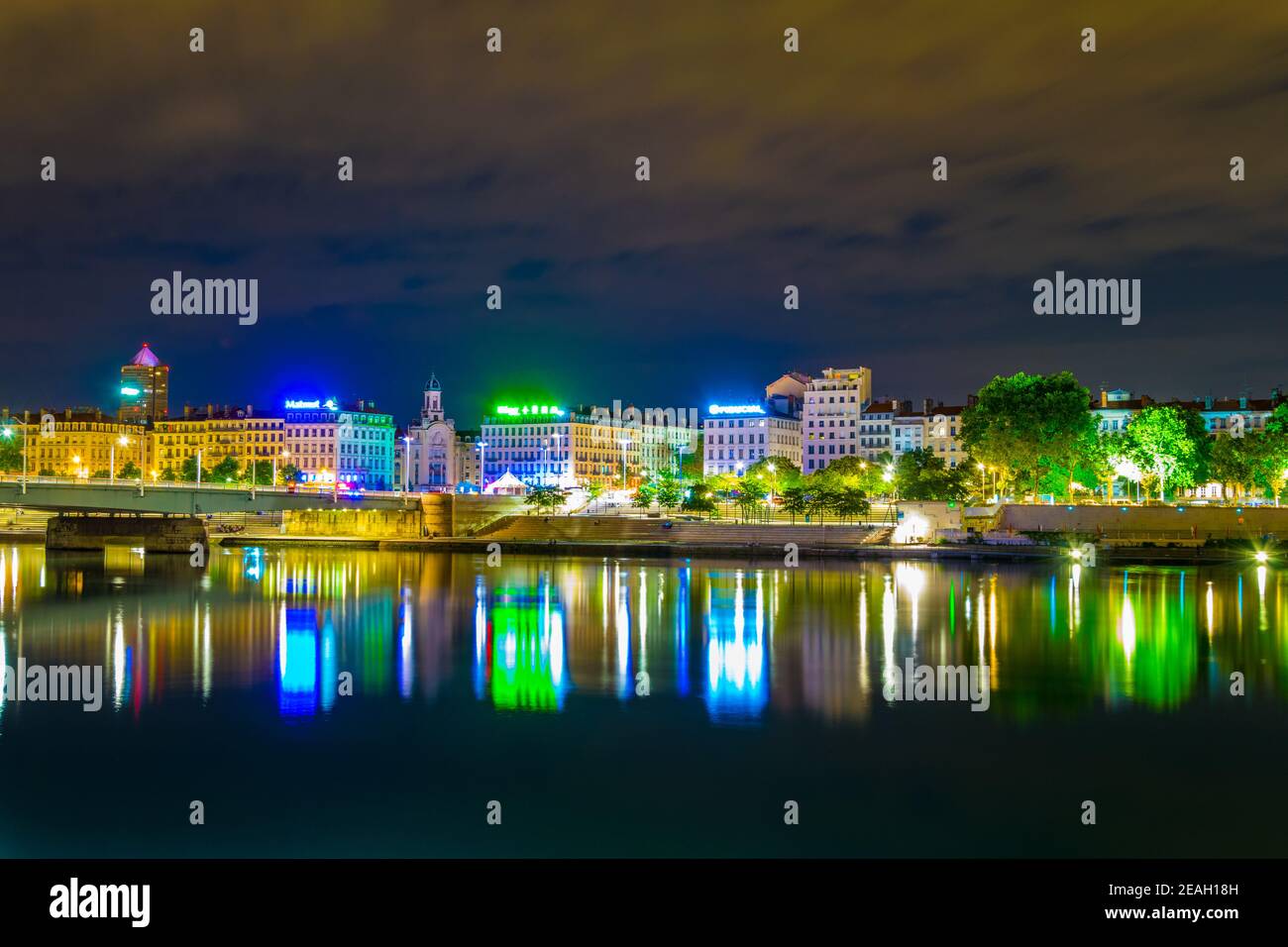 Night view of illuminated riverside of Rhone river in Lyon, France ...