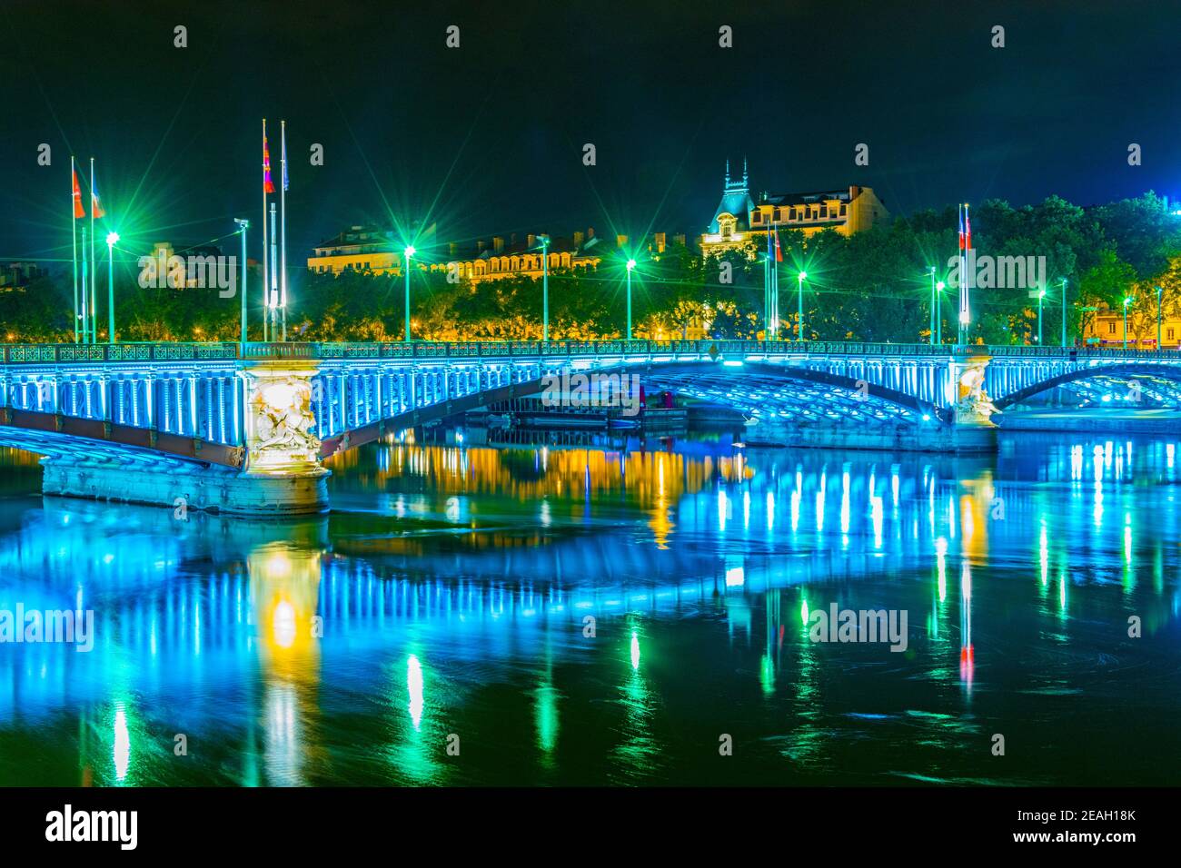 Night view of illuminated riverside of Rhone river in Lyon, France ...
