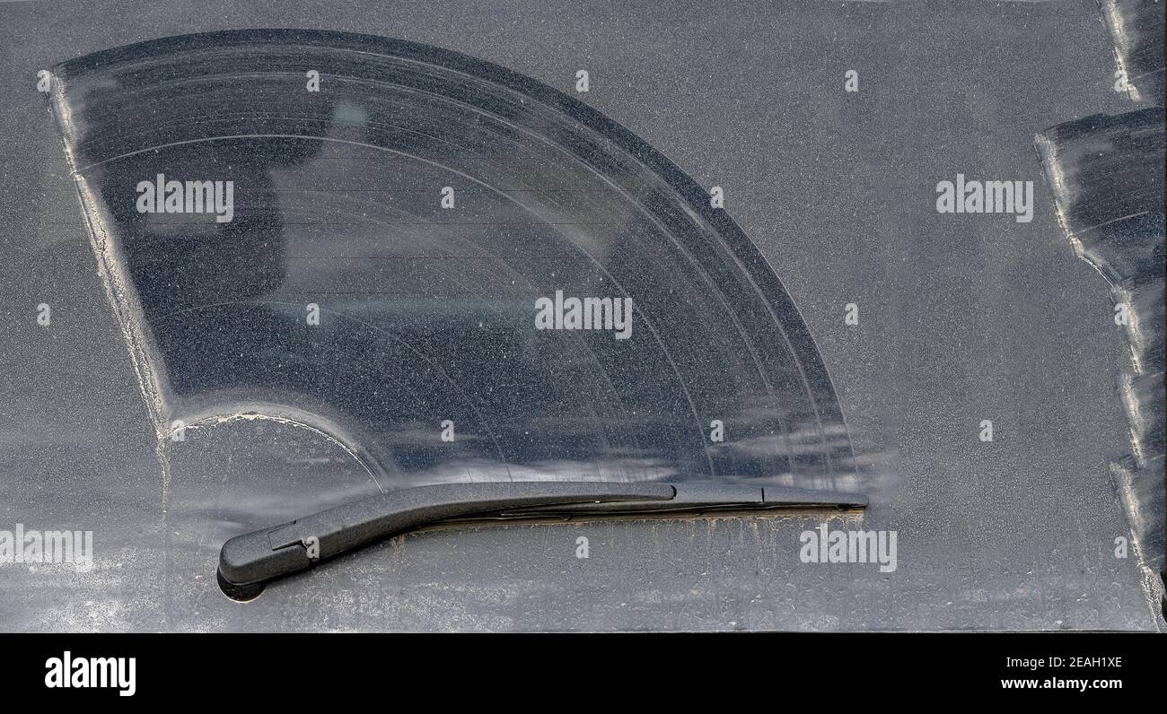 rear window of a dirty car covered with a layer of dry dirt defective ...