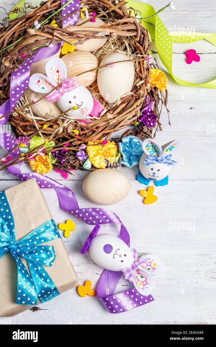 Handmade traditional Easter symbols concept. Cute rabbits from eggs in ...