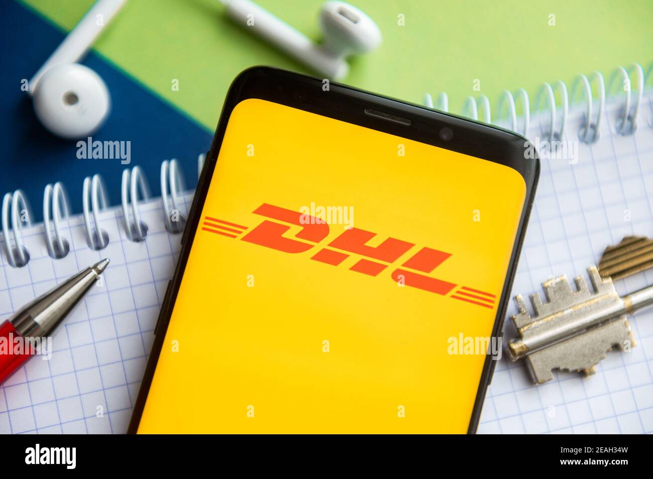 In this photo illustration, a DHL logo seen displayed on a smartphone ...