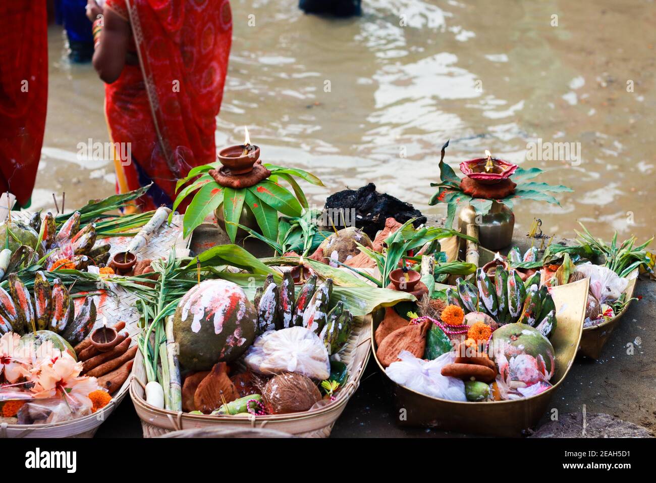 holy offerings of fruits flowers lamps and cloths in river to sun god ...