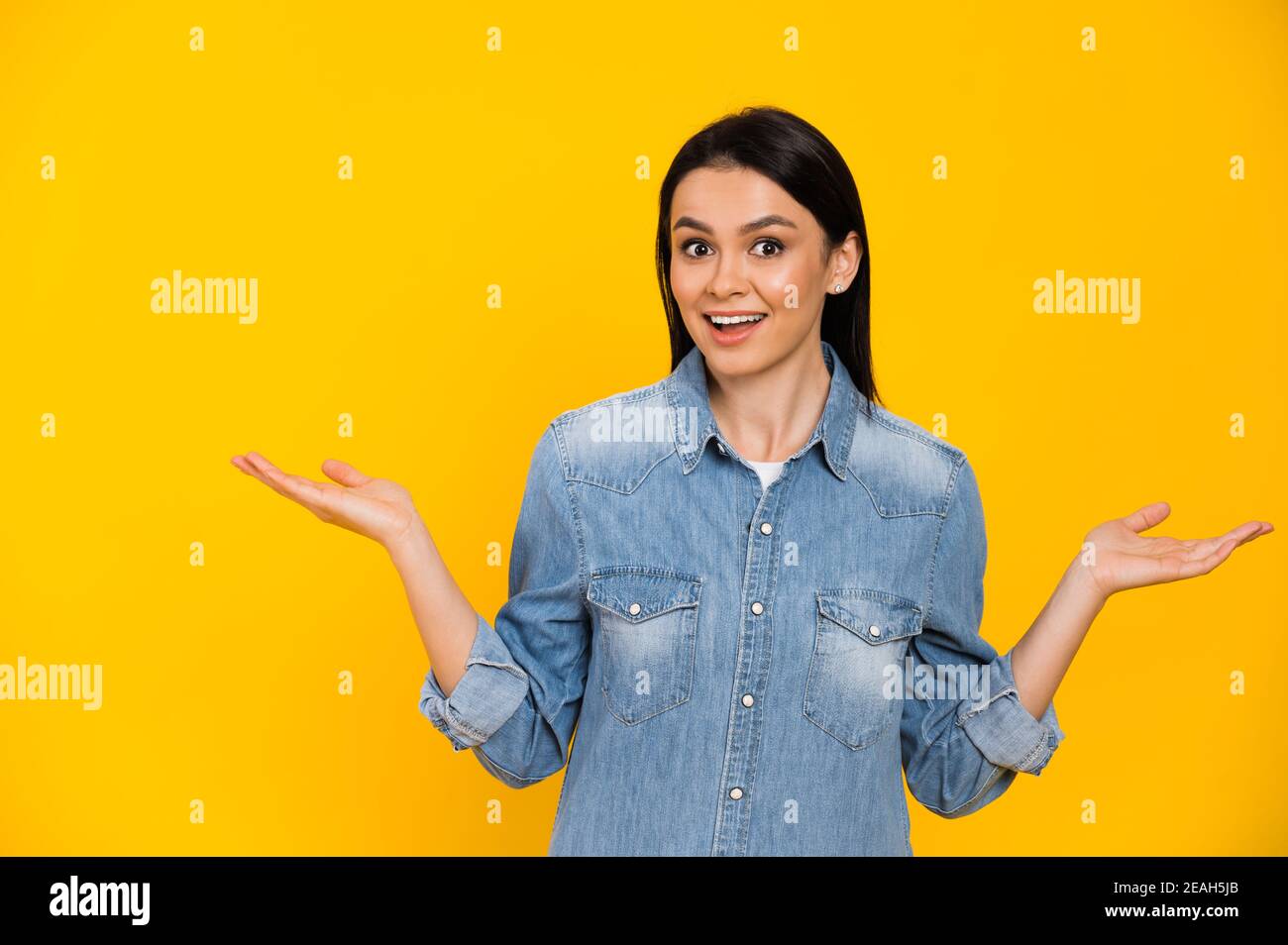 Confused surprised caucasian pretty girl in denim shirt standing on ...
