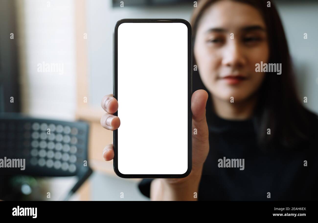 Woman show smartphone with blank white screen Stock Photo - Alamy
