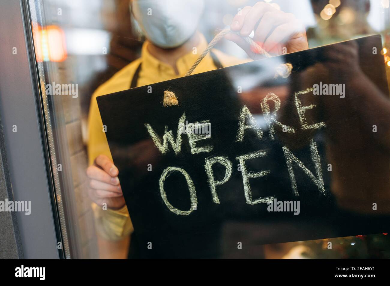 Close-up photo of a signboard OPEN at the entrance to a restaurant or ...