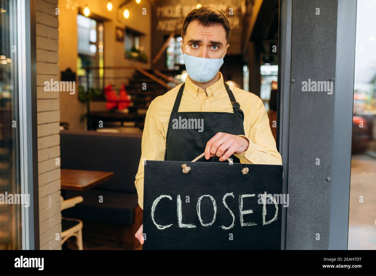 Sad waiter, barista or small business owner. Unhappy man in a medical ...