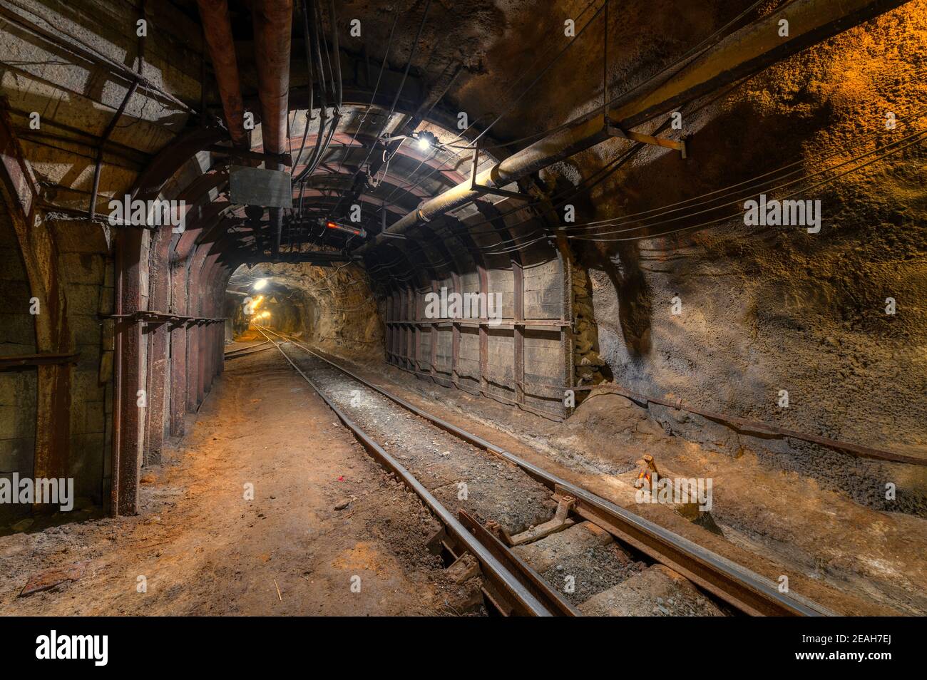 Tunnel of the mining of an underground mine. Lots of pipelines on the ...