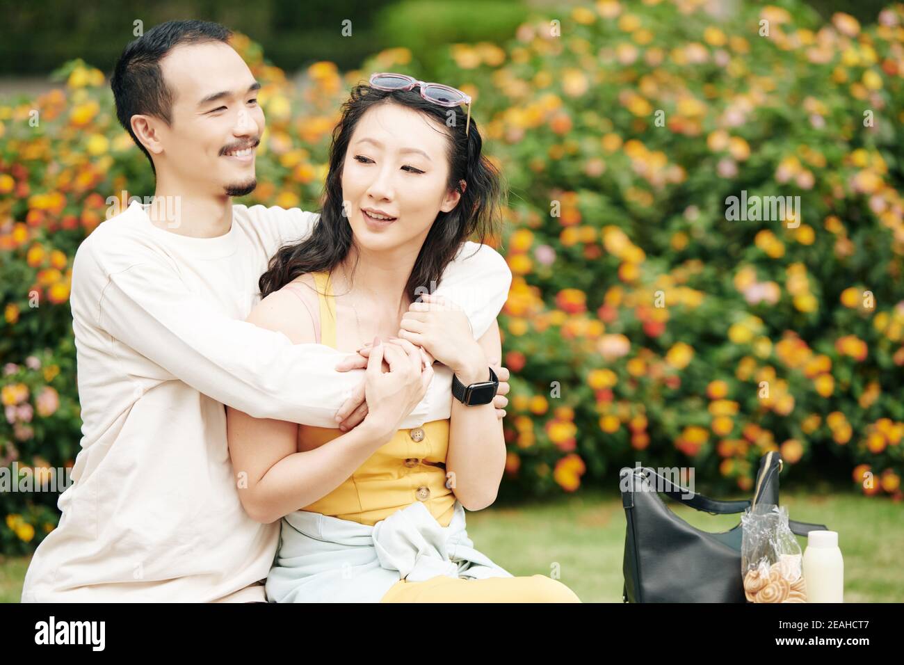 Chinese man hugging his girlfriend Stock Photo - Alamy