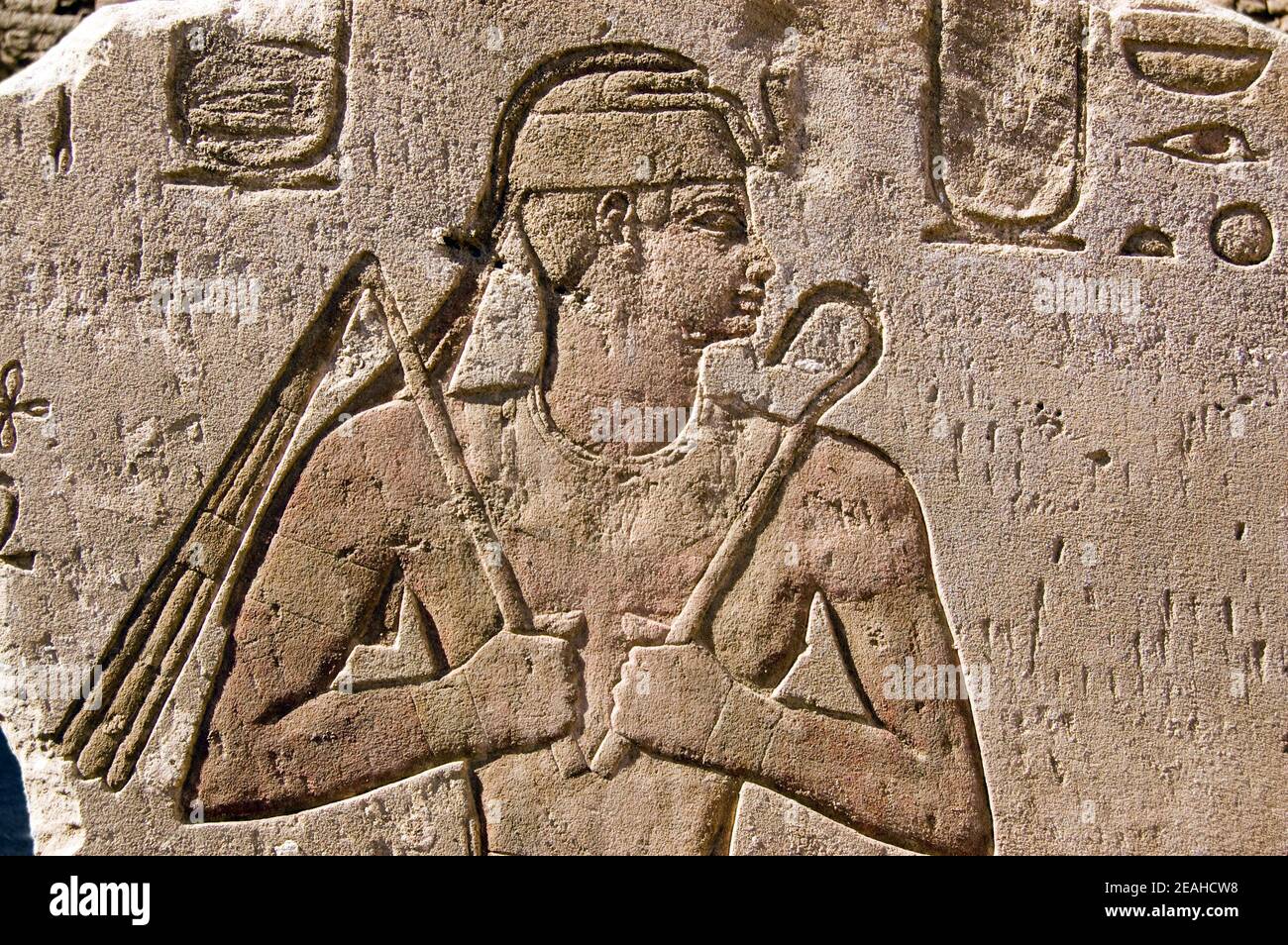 Ancient Egyptian hieroglyphic carving of a Pharaoh holding a flail, or ...