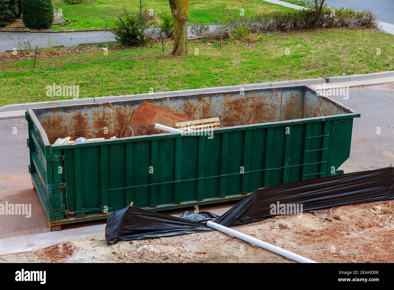 Dumpsters construction garbage in a wood frame structure of Incomplete ...