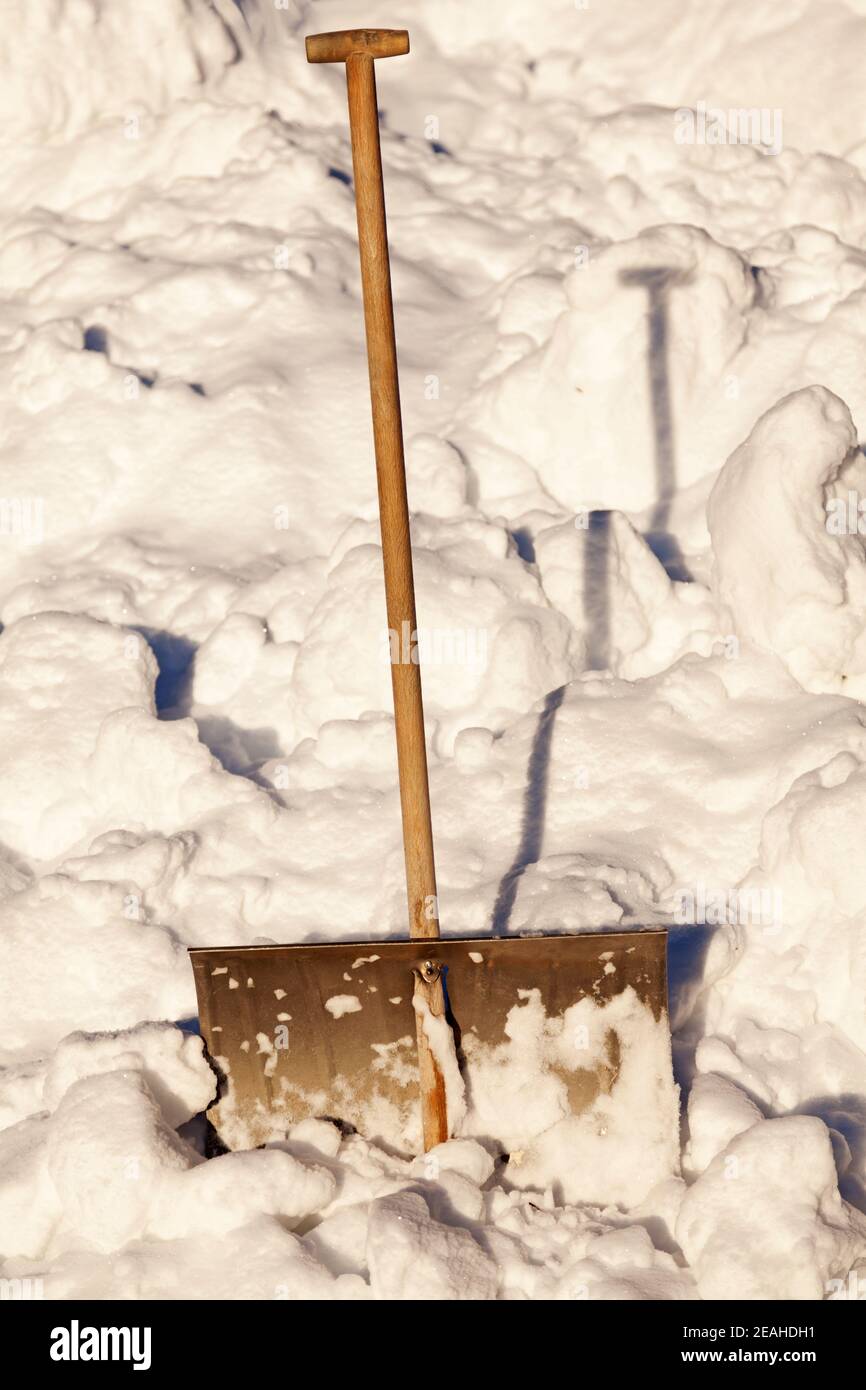 snow shovel and lots of snow in sunlight Stock Photo - Alamy