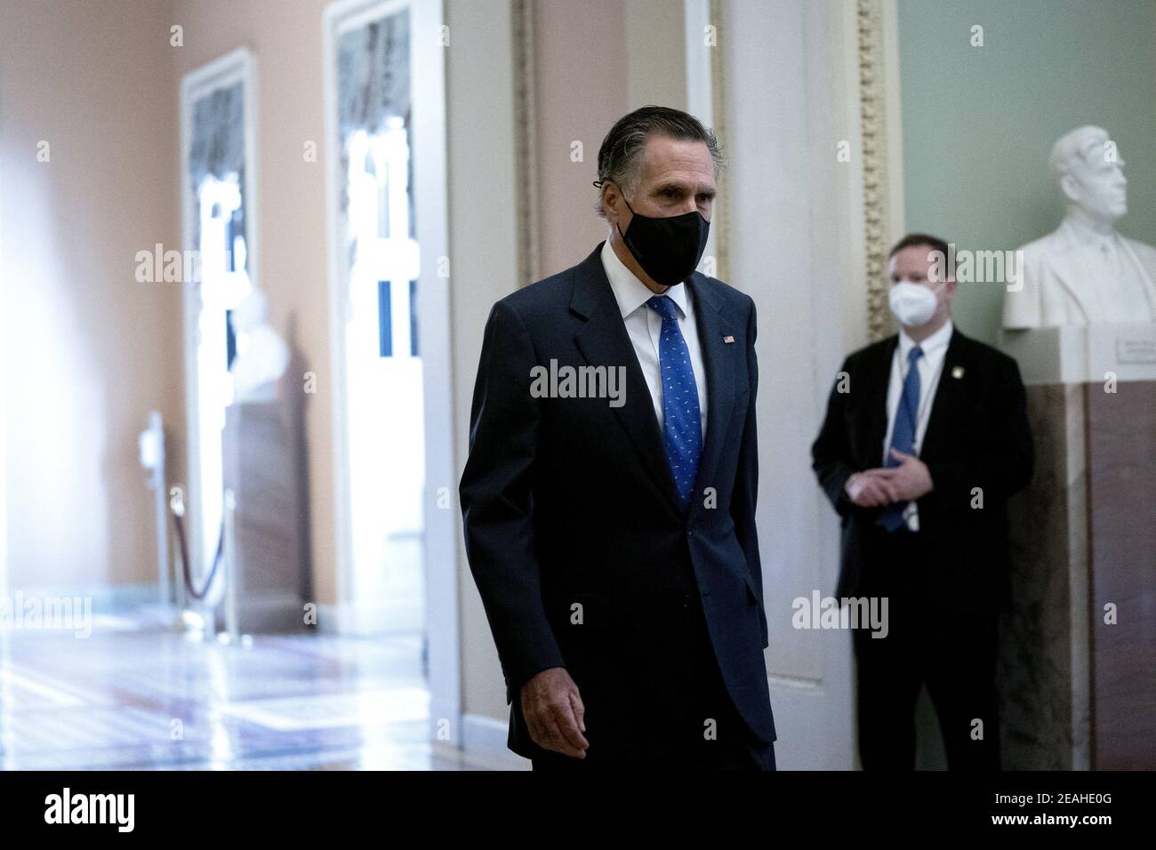 Senator Mitt Romney, a Republican from Utah, wears a protective mask ...