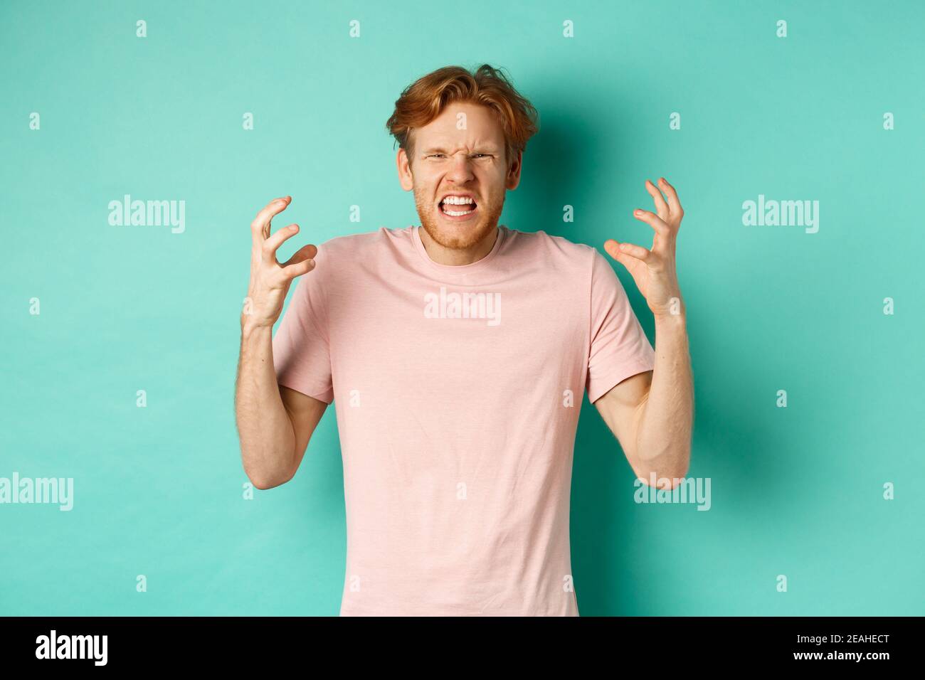Annoyed and pissed-off redhead guy looking angry, shouting and ...