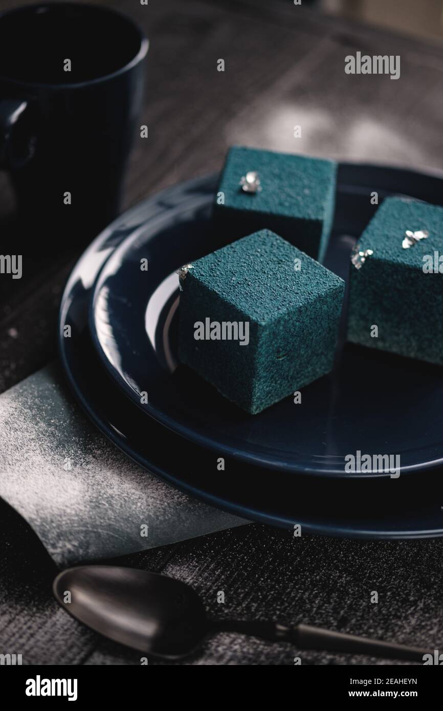 Blue cake filled with orange and tangerine in the shape of a cube ...