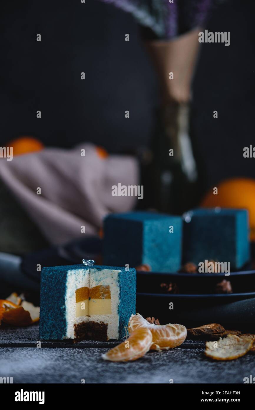 Blue cake filled with orange and tangerine in the shape of a cube ...