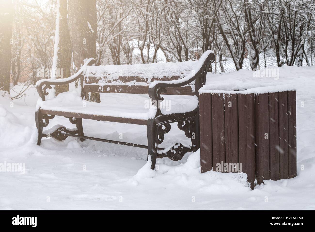 Snowy bench in the park. Snowfall and weather Stock Photo - Alamy