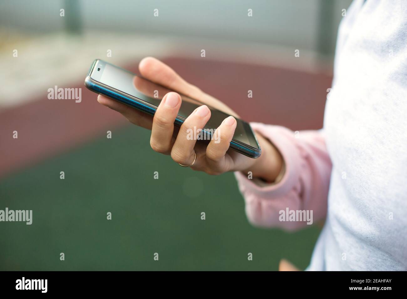 Smartphone in women's hands close-up. Using the phone, fingers on the ...