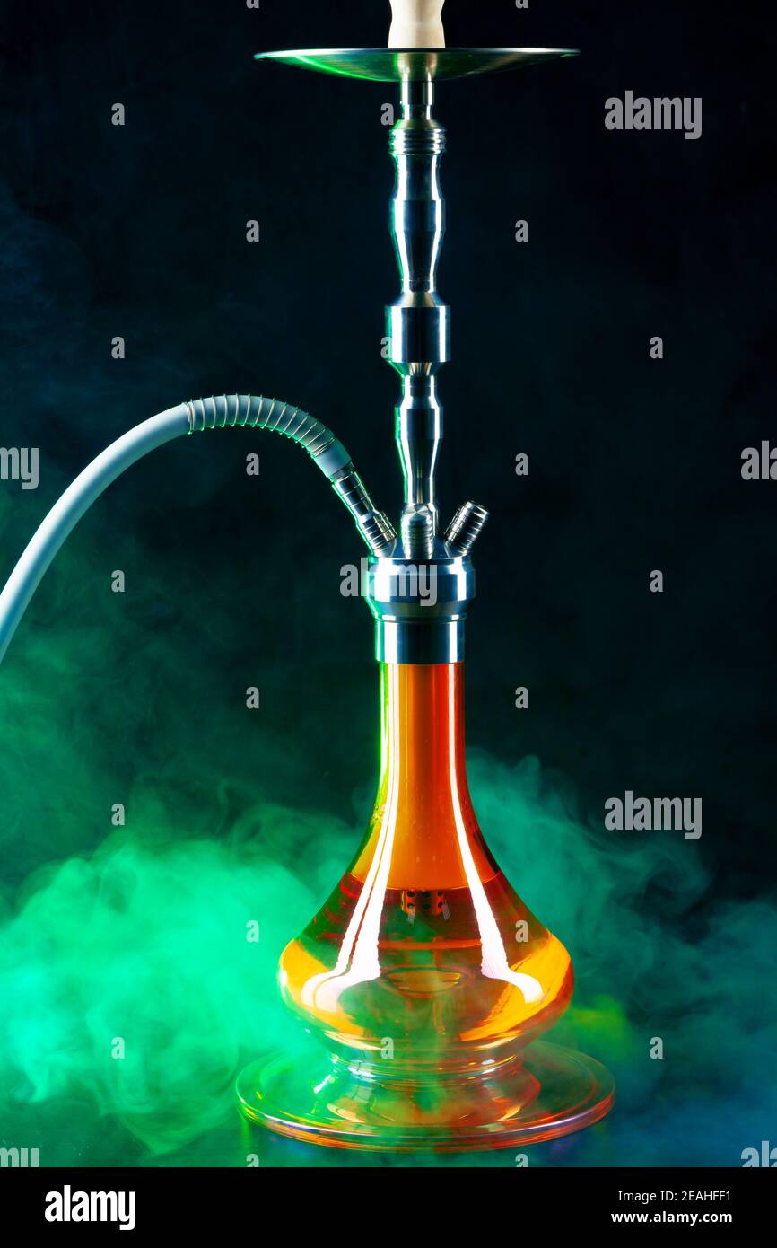 Modern hookah with smoke in dark club light Stock Photo - Alamy