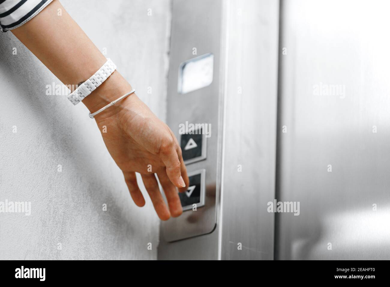 Female hand pushing the button of elevator Stock Photo - Alamy