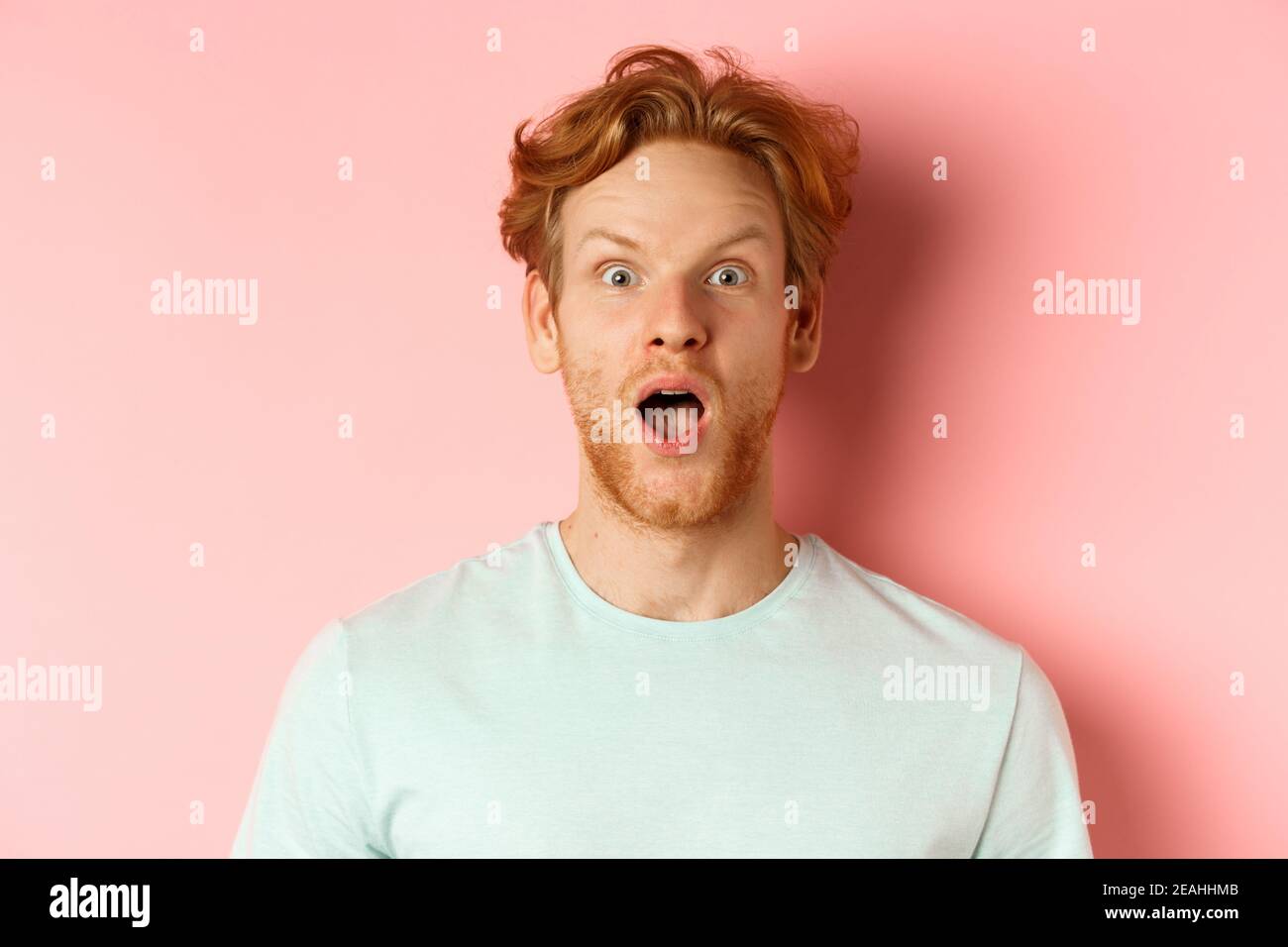 Face of surprised redhead man reacting to cool promo offer, raising ...