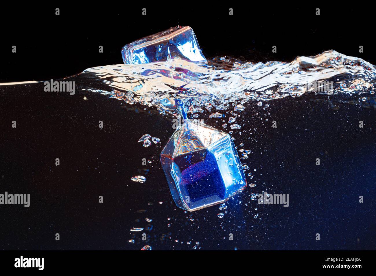 Hourglass diving into the water against black background Stock Photo ...