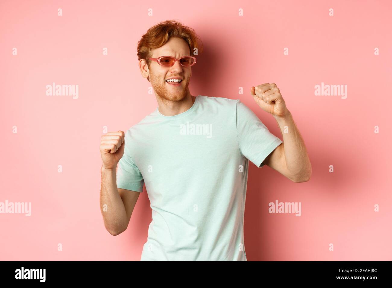 Tourism and vacation concept. Cheerful redhead man having fun at party ...