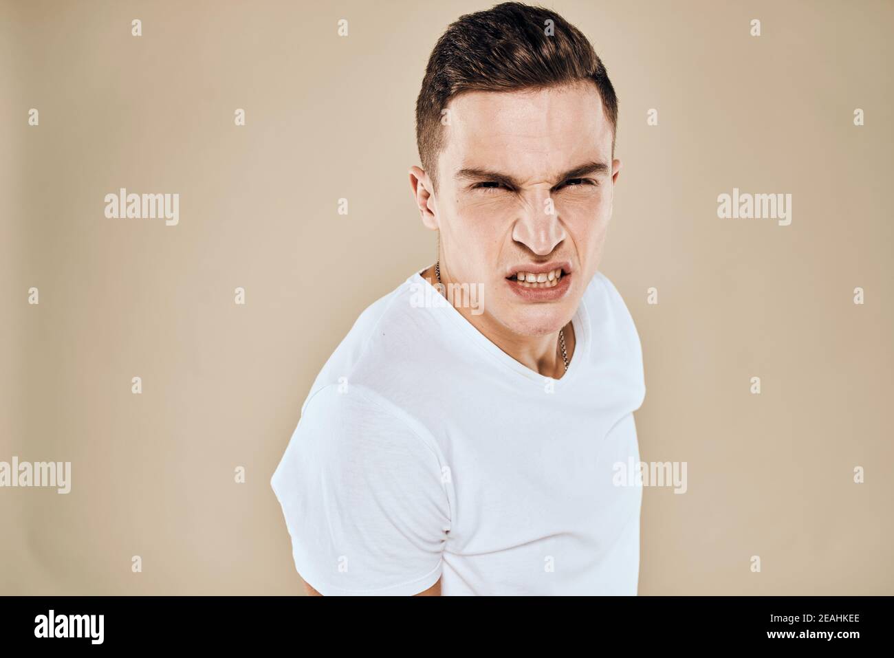 Man with displeased facial expression emotions white t-shirt gestures ...