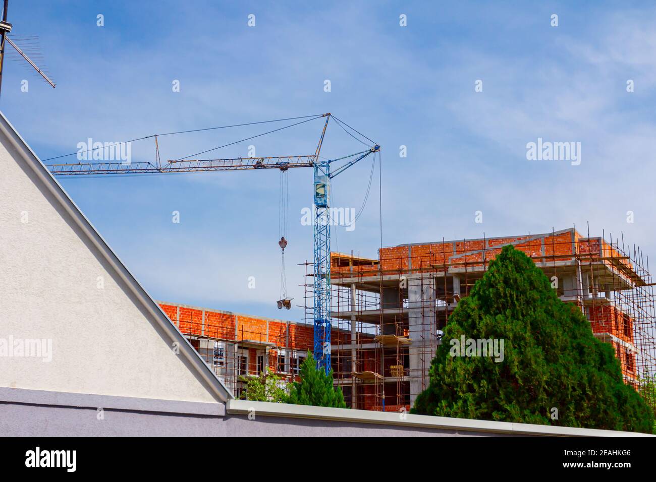 Scaffold and crane are placed against unfinished edifice, building ...