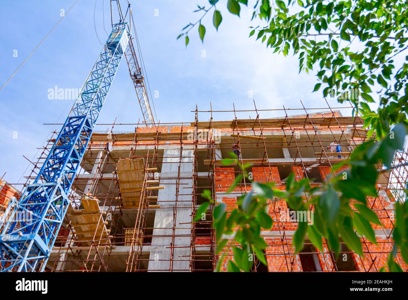 Scaffold and crane are placed against unfinished edifice, building ...