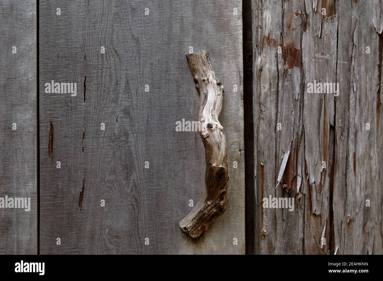 A simple solution for a door handle, a rustic branch has been attached ...