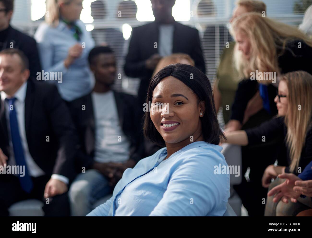 Young black woman smiling to camera in office Stock Photo - Alamy
