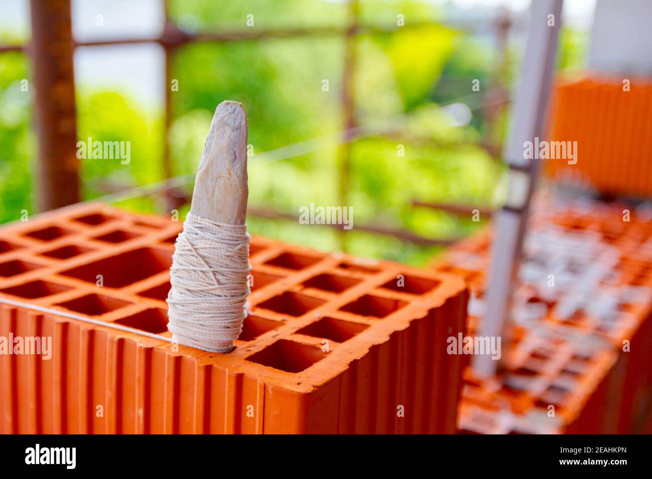 Spool of construction string line placed in red blocks. Tool to help ...