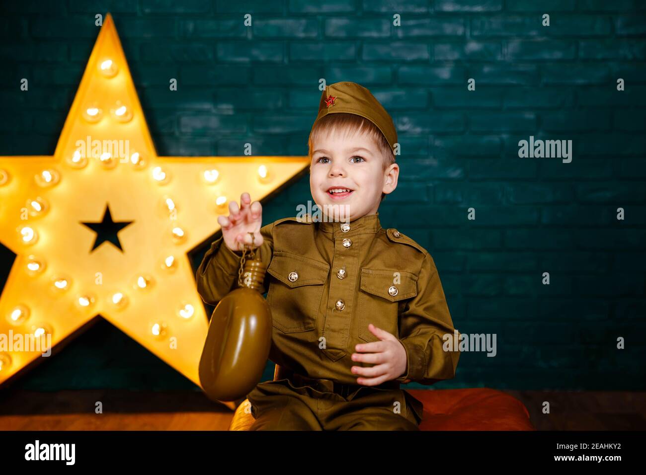 Funny smiling preschooler boy in military uniform. Boy playing soldier ...