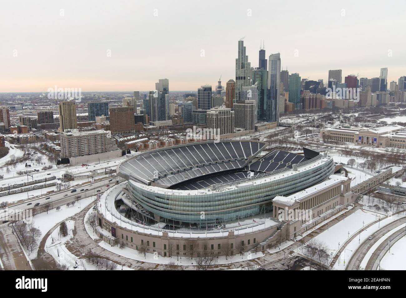 An aerial view of a snow-covered Soldier Field and the downtown skyline ...