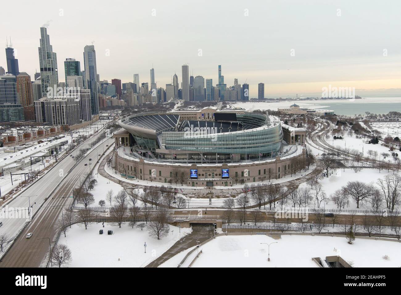 An aerial view of a snow-covered Soldier Field and the downtown skyline ...