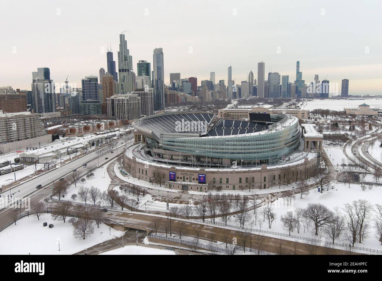 An aerial view of a snow-covered Soldier Field and the downtown skyline ...