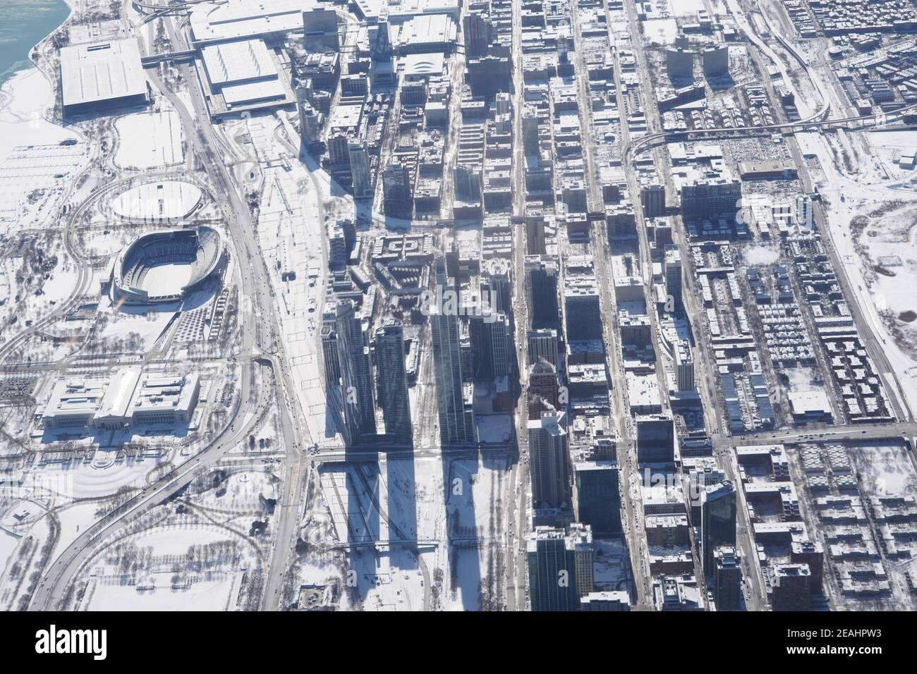 An aerial view of a snow-covered Soldier Field and the downtown skyline ...